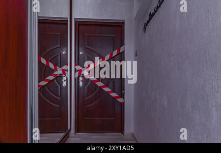 The entrance door to the apartment, police tape, secured the crime ...