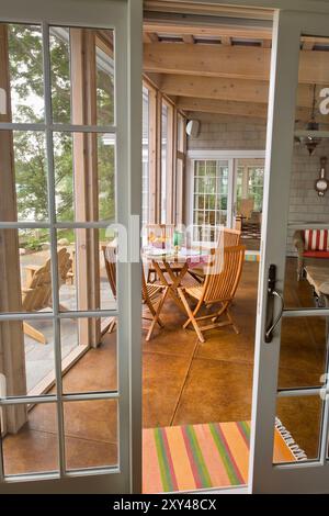 Breezeway with floor to ceiling screens and view out to lake Stock ...