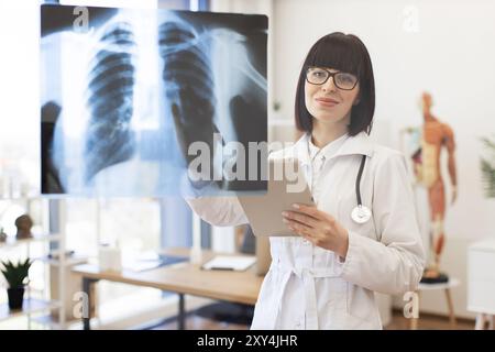 Female doctor examining X-rays and taking notes in modern medical ...