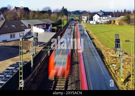 Two passenger trains meet on the open road Stock Photo - Alamy