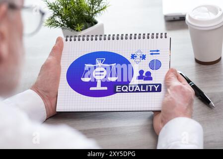 Hand holding a notepad with equality concept Stock Photo - Alamy