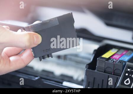 Putting new printer cartridge into the printer, inkjet Stock Photo - Alamy