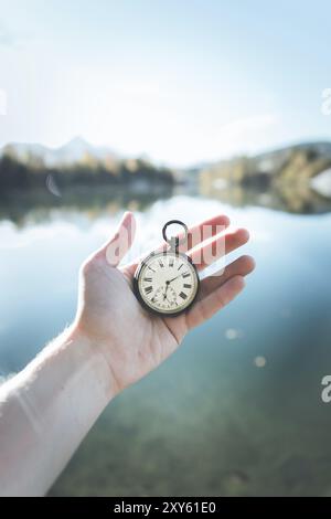 Hand held stop watch outdoors, autumn, blurry background Stock Photo ...