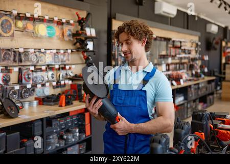 Worker testing big angle grinder at hardware store Stock Photo - Alamy