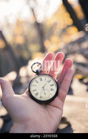 Hand held stop watch outdoors, autumn, blurry background Stock Photo ...