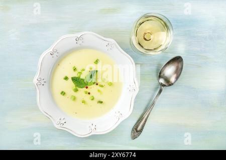 Vichyssoise, French cold soup, shot from the top with a glass of white ...