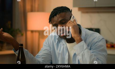 alcoholic with smartphone drinking beer at home Stock Photo - Alamy