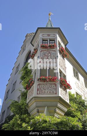 Gasthof Baeren with oriel and ivy and historic upper gate tower, town ...