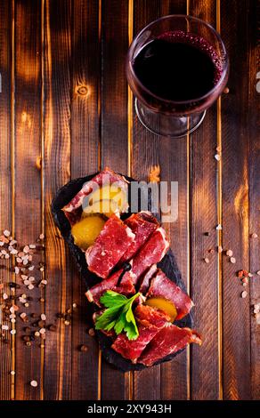 Flat slices of square sandwich ham with herbs. Dark background. Top ...