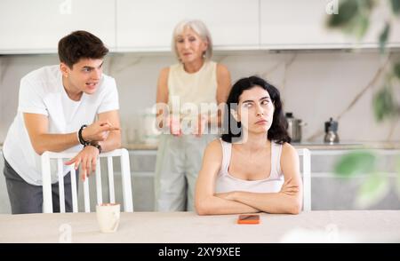 Sad woman dont speaking after discord with mother and husband standing ...