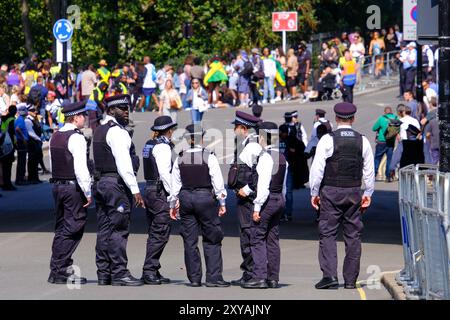 Police officers await instruction at the Notting Hill Carnival as the ...
