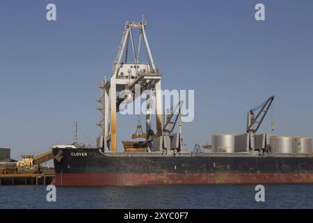 A cargo ship loads and unloads goods at the fully automated terminal of ...