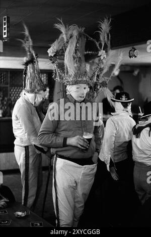 Biddy Boys wearing the traditional tall straw conical headdress. He is ...