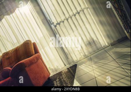 The rising sun shines through the window into a living room Stock Photo ...