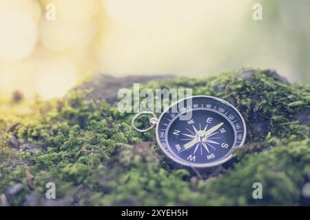 Vintage compass lying on the floor. Adventure and discovery concept ...