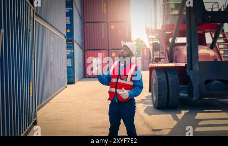 Portrait of Engineer or foreman wears PPE checking container storage ...