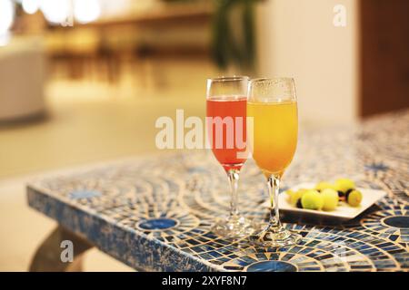 Two flute cocktail glasses on the table Stock Photo - Alamy