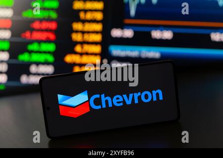 In this photo illustration, a Chevron logo is seen displayed on a phone ...