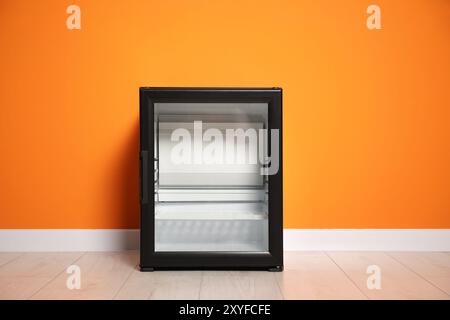 Empty modern mini refrigerator near white wall Stock Photo - Alamy