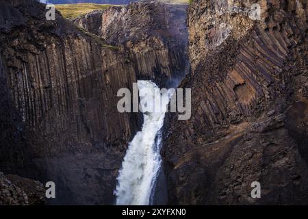 Waterfall gushing through volcanic rock on Iceland Stock Photo - Alamy