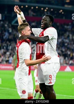 AMSTERDAM - (l-r) Kenneth Taylor of Ajax, Brian Brobbey of Ajax celebrate the 1-0 during the ...