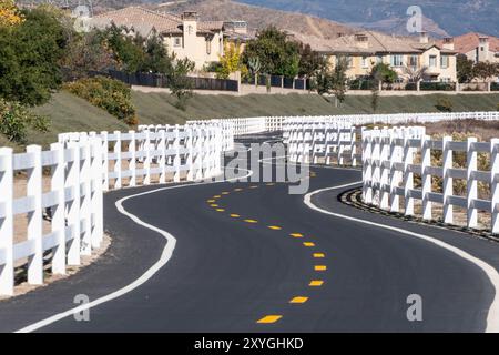 Suburban bike path with white fencing along the San Francisquito Creek ...