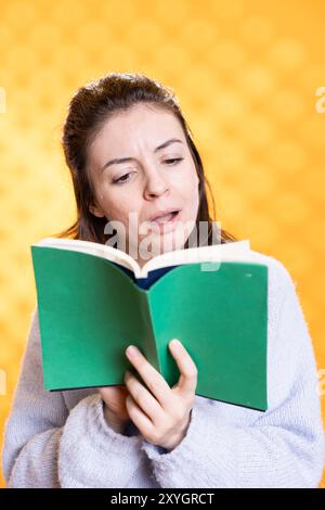 woman reader reading. shocked student on yellow background. girl study ...