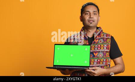 Upbeat tech specialist doing promotion using isolated screen laptop ...