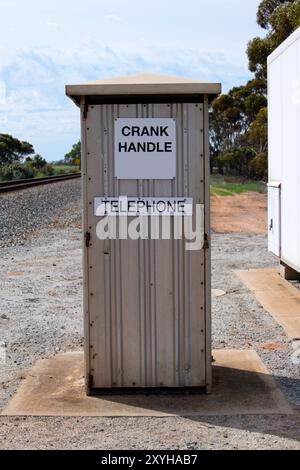 Old crank handle telephone box alongside of railway , Western Australia ...