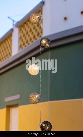 Decorative hanging balls in front of bright building and window Stock ...