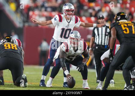 New England Patriots quarterback Drake Maye (10) warms up before an NFL football game against ...