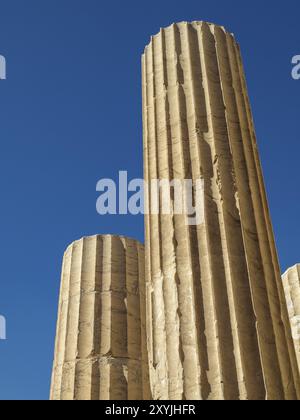 Vertical shot of a blue clear empty hotel pool at sunset under a cloudy ...