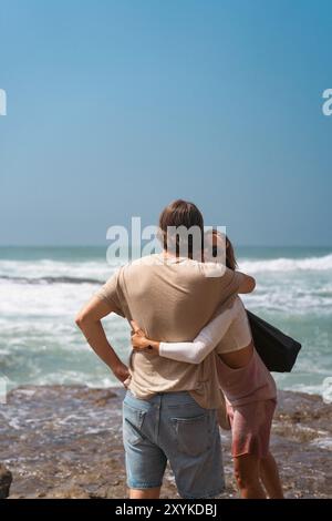 Two male friends hugging and looking at camera outdoors Stock Photo - Alamy