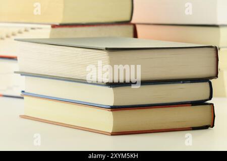Stacks of books on table on natural background Stock Photo - Alamy