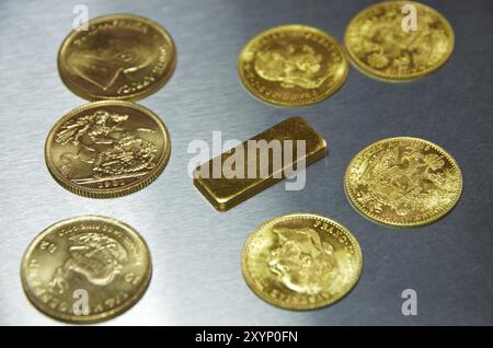 Gold bar an coins on a scales Stock Photo - Alamy