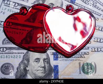 Red hearts on dollar bills. Concept of selling love for money Stock ...