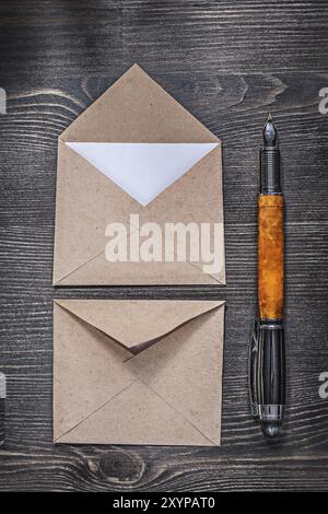 Old letter, fountain pen and envelopes on wooden table, top view. Space ...