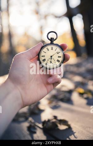 Hand held stop watch outdoors, autumn, blurry background Stock Photo ...