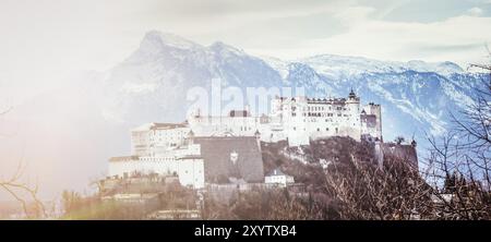 Fortress Hohensalzburg with snowy mountains in the background, autumn ...