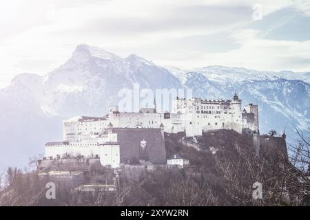 Fortress Hohensalzburg with snowy mountains in the background, autumn ...