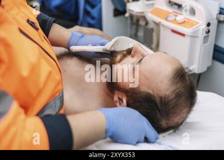 Paramedic putting a cervical collar to a patient in the ambulance Stock ...
