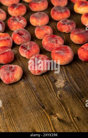 washed peaches on the table, flat ripe and soft peaches after washing ...