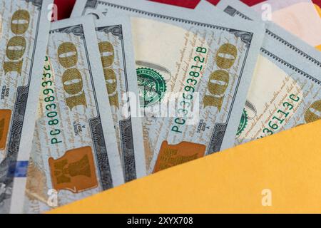 new yellow paper envelopes with American dollars, folded American 100 ...
