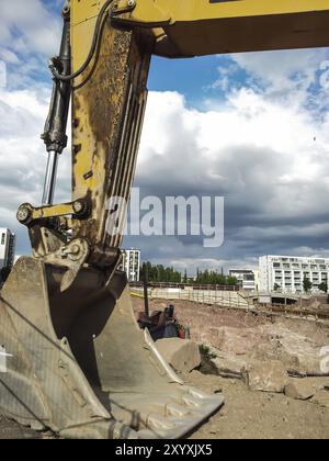 closeup of a shovel with excavator in the background Stock Photo - Alamy