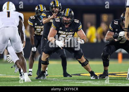 Missouri offensive lineman Drake Heismeyer holds a flag as he is ...