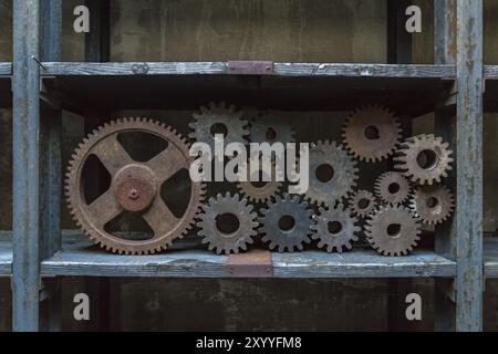 Interlocking gear wheels in front of a black wall Stock Photo - Alamy