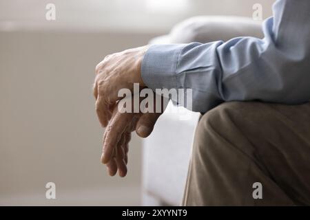 cropped view of aged man with parkinson syndrome and hands tremor ...
