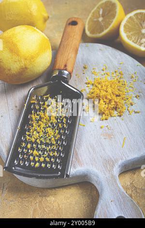 Fresh lemons, zest and tools on wooden table, closeup Stock Photo - Alamy