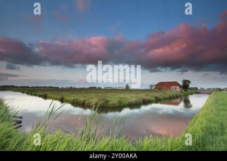 sunset over charming Dutch house by river Stock Photo - Alamy