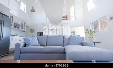 Interior of light living room with soft couch, armchair and coffee ...